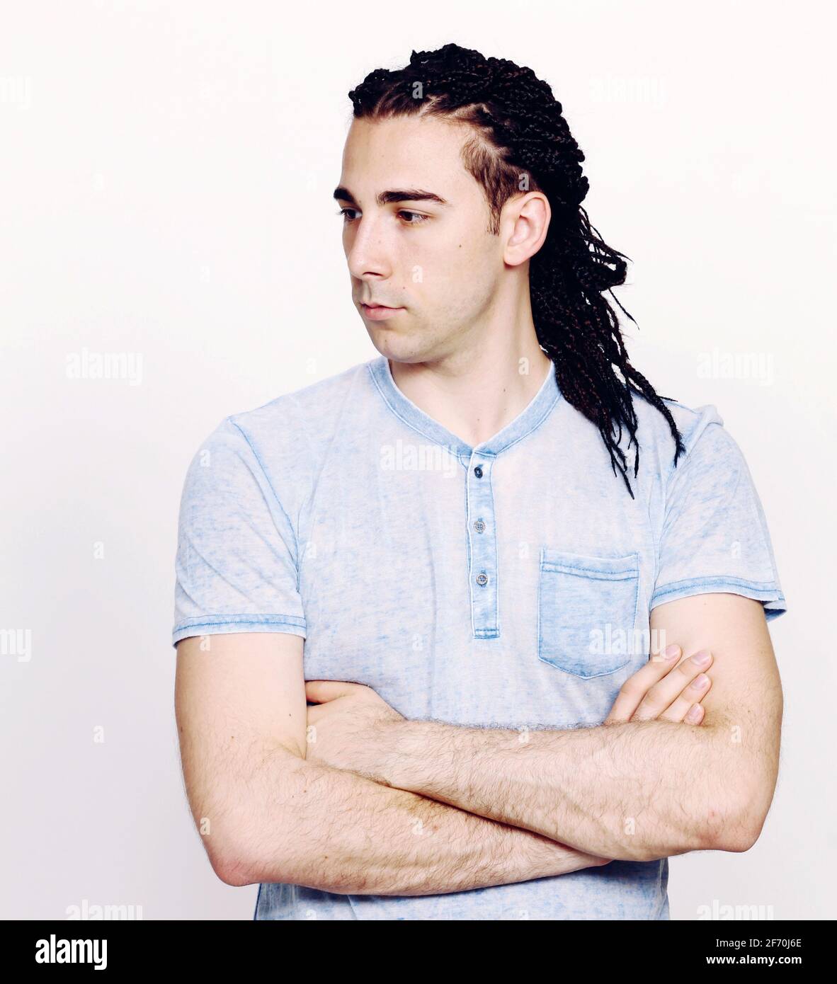 Stylish male model with afro braids posing in studio on isolated ...