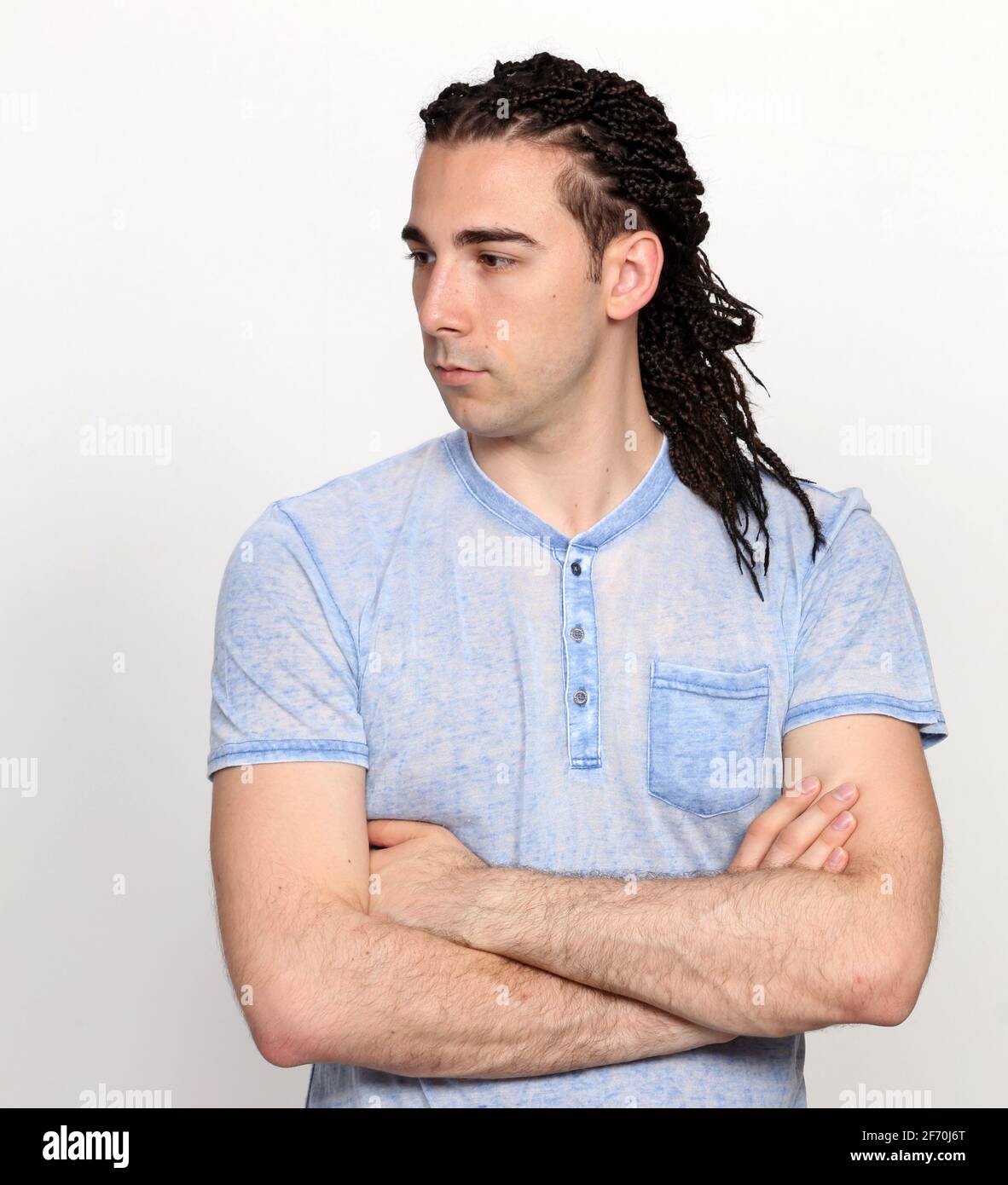 Stylish male model with afro braids posing in studio on isolated ...