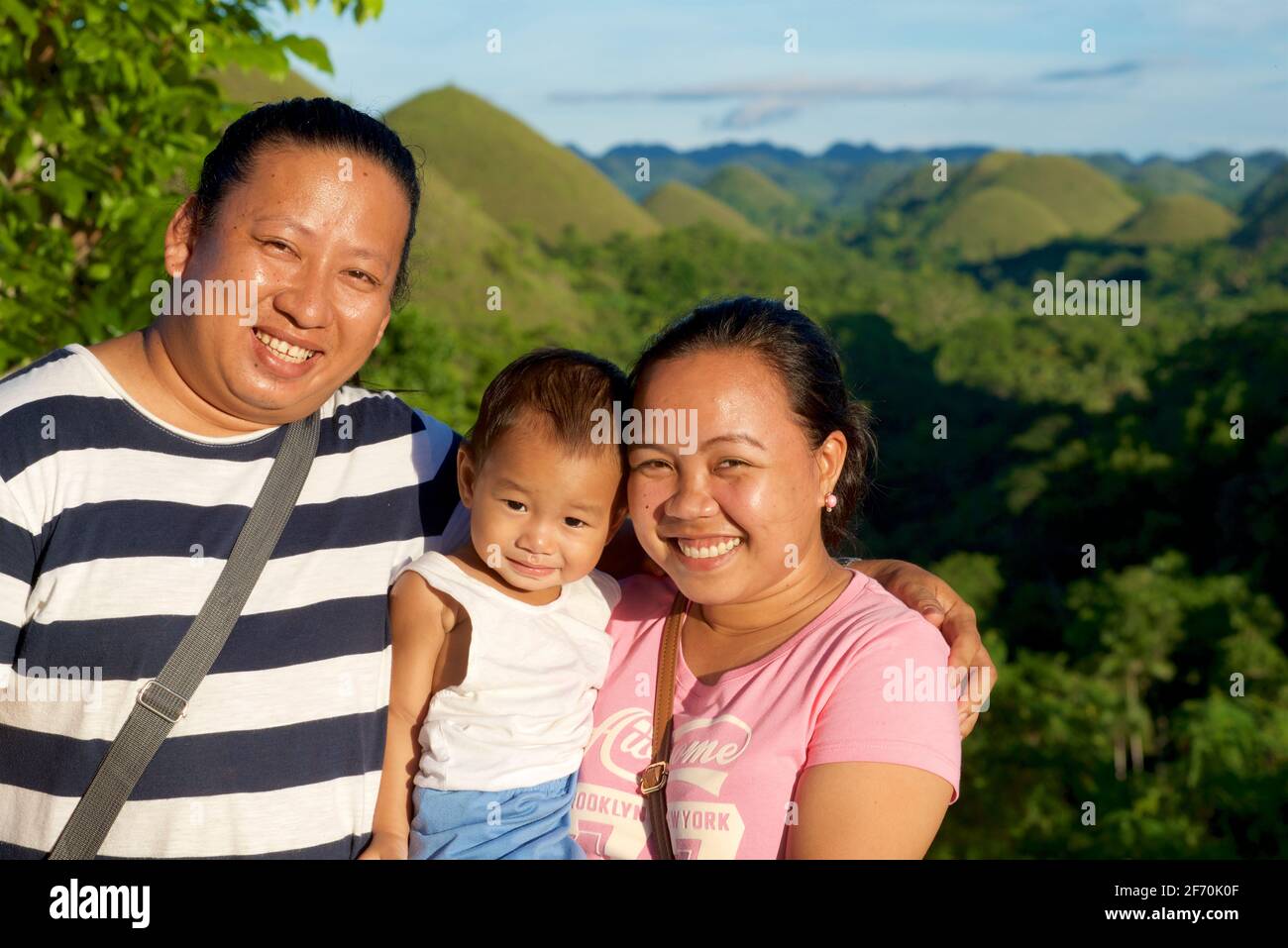 Young Filipino family - parents and child at the 'Chocolate Hills ...