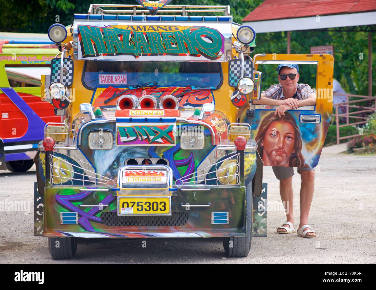 Independent Western travel correspondent stands at the door to a ...