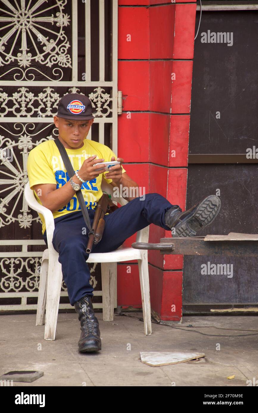 Security guard with a gun outside a commercial premises in Tagbilaran ...