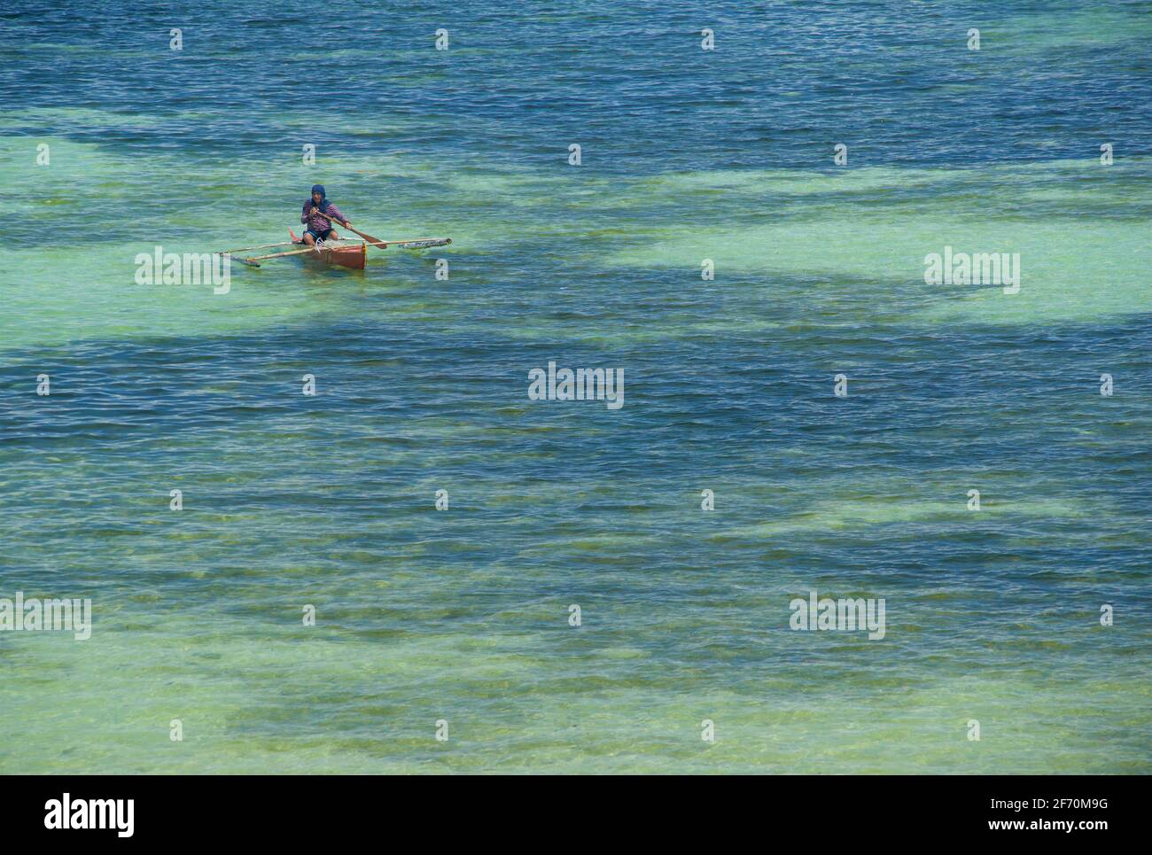 A fleet of outrigger canoes anchored off Doljo beach, Panglao Island ...