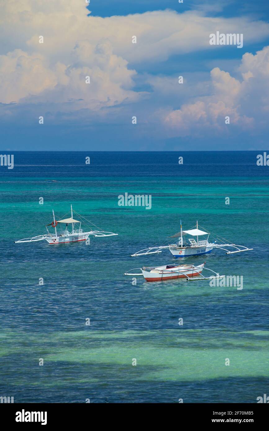 A fleet of outrigger canoes anchored off Doljo beach, Panglao Island ...