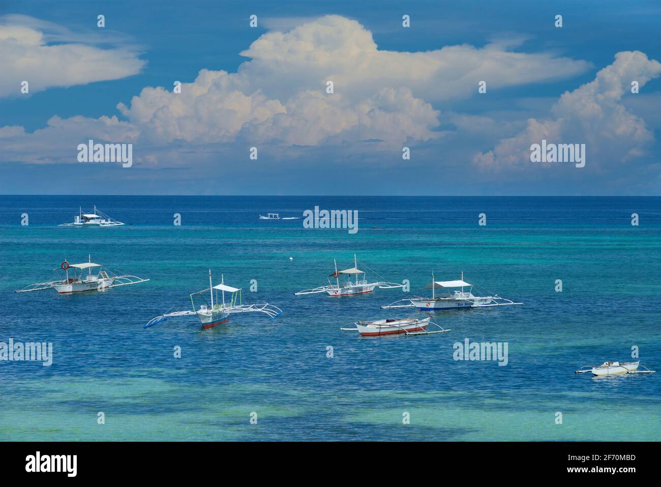 A fleet of outrigger canoes anchored off Doljo beach, Panglao Island ...