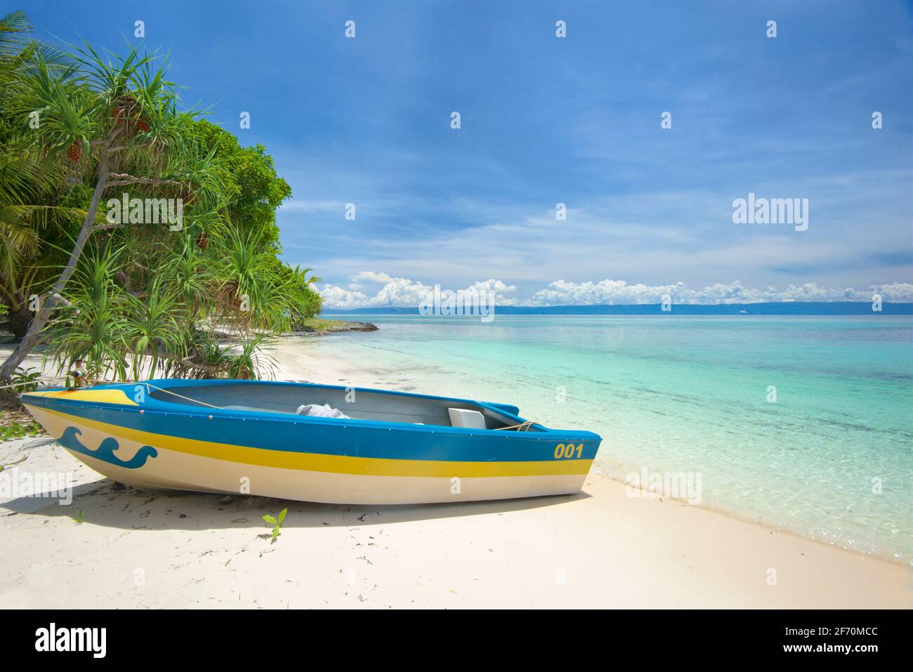 Sandy tropical beach near Doljo beach, with beached boat and turquoise ...