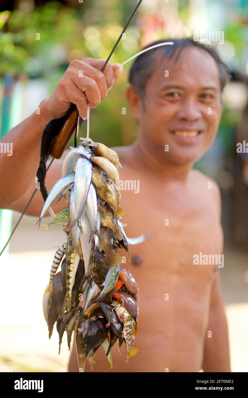 Filipino man with a fresh catch of fish. Moalboal, Cebu, Philippines ...