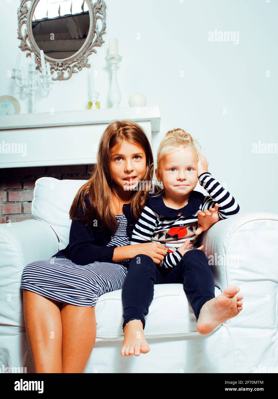two cute sisters at home interior playing, little happy smiling girl in ...