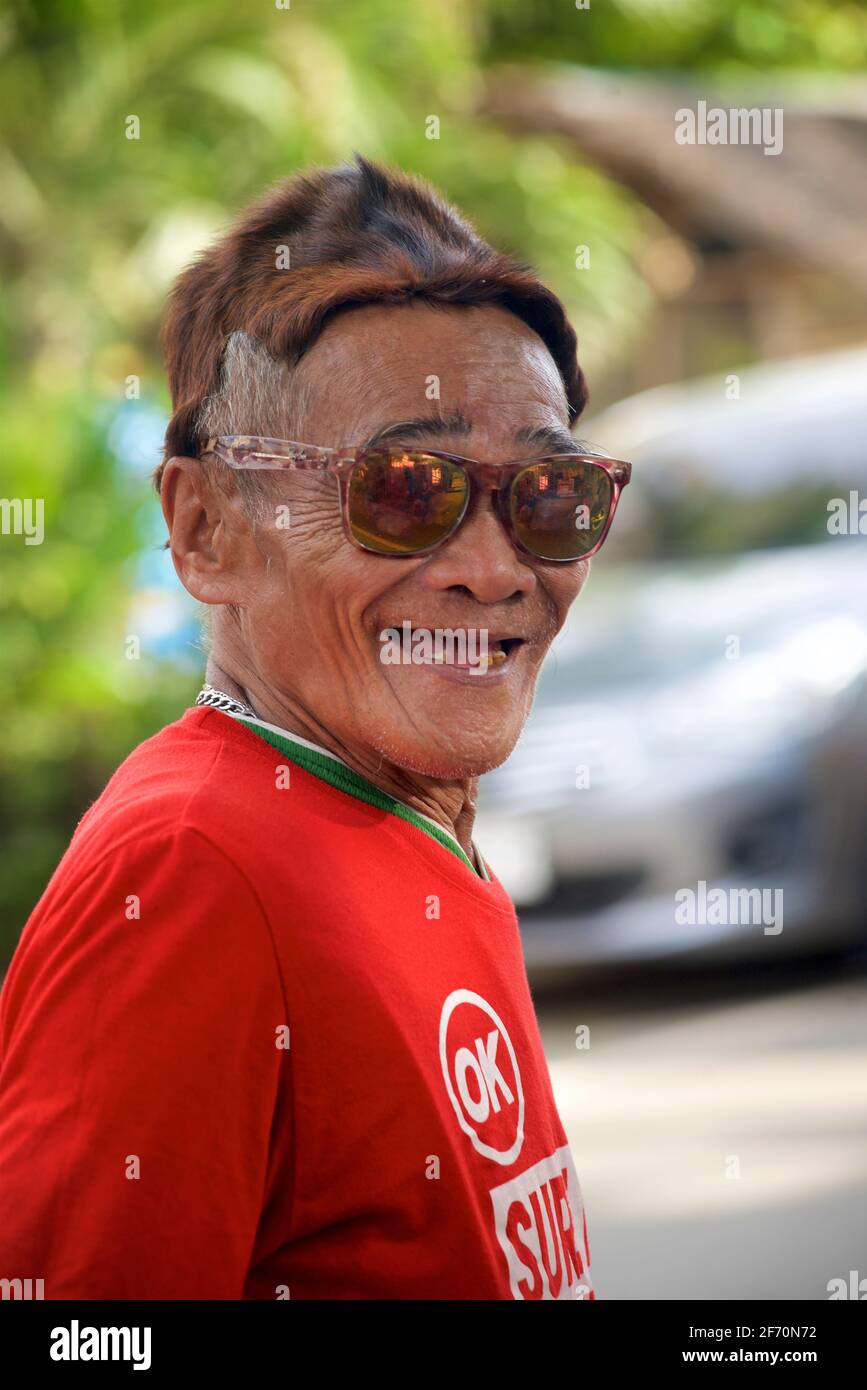 Portrait of a smiling, elderly Filipino man in a procession for Flores ...