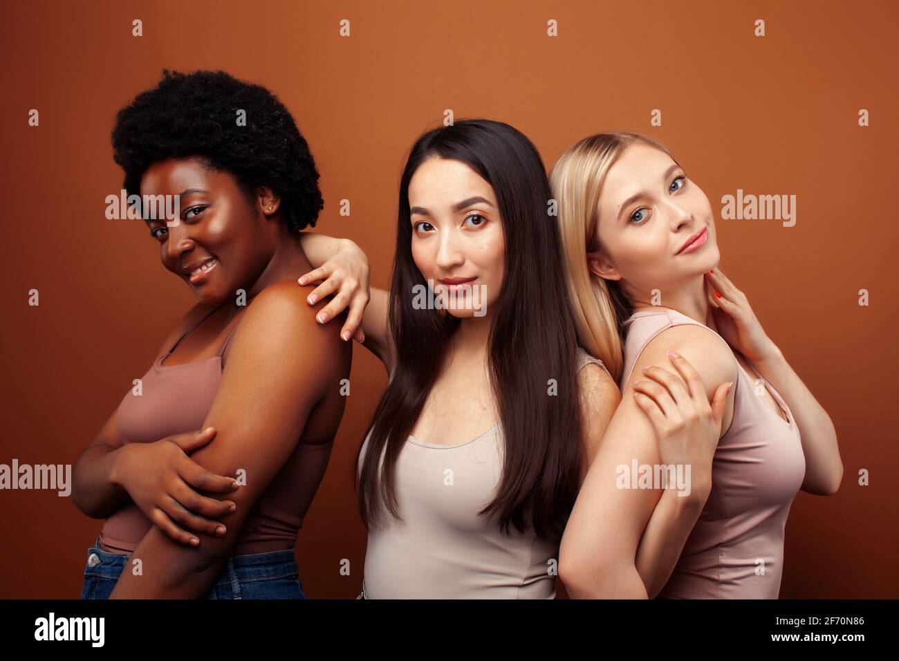 young pretty asian, caucasian, afro woman posing cheerful together on ...