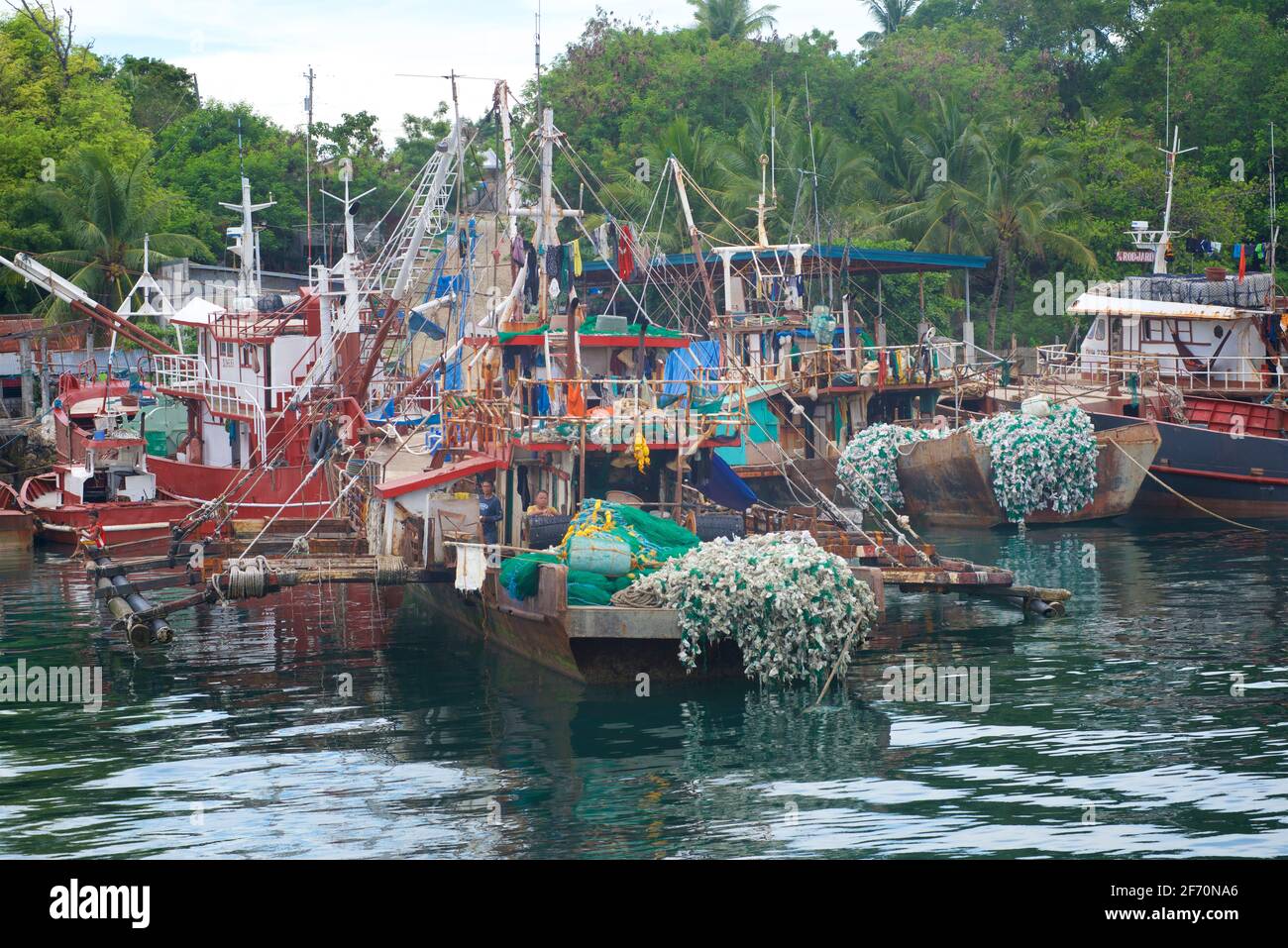Fishing boats line the coastal of Punta, Cebu Island. On approach to ...