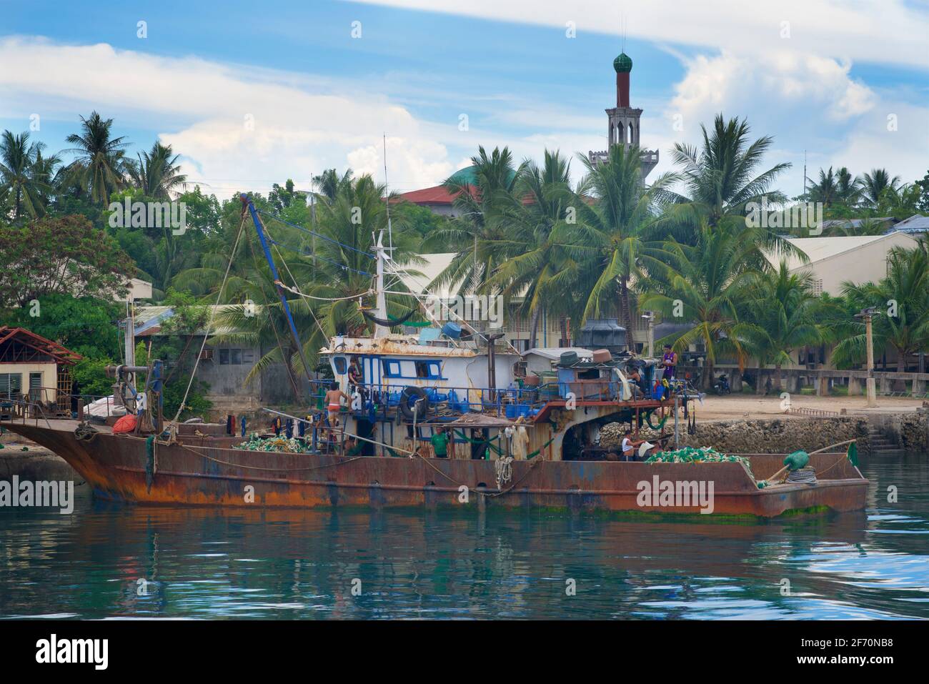 Fishing boats line the coastal of Punta, Cebu Island. On approach to ...