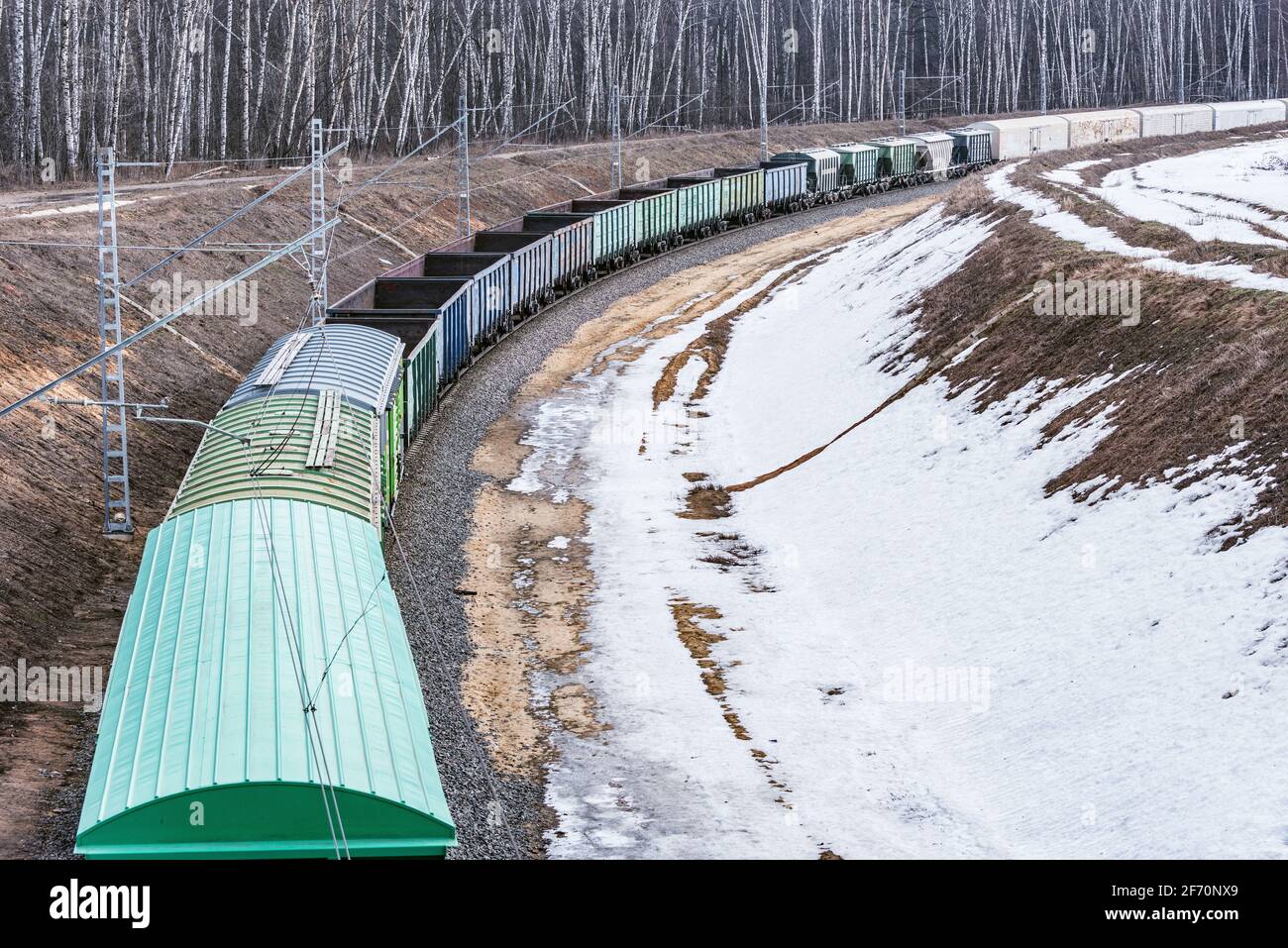 Long freight train approaches to the station Stock Photo - Alamy
