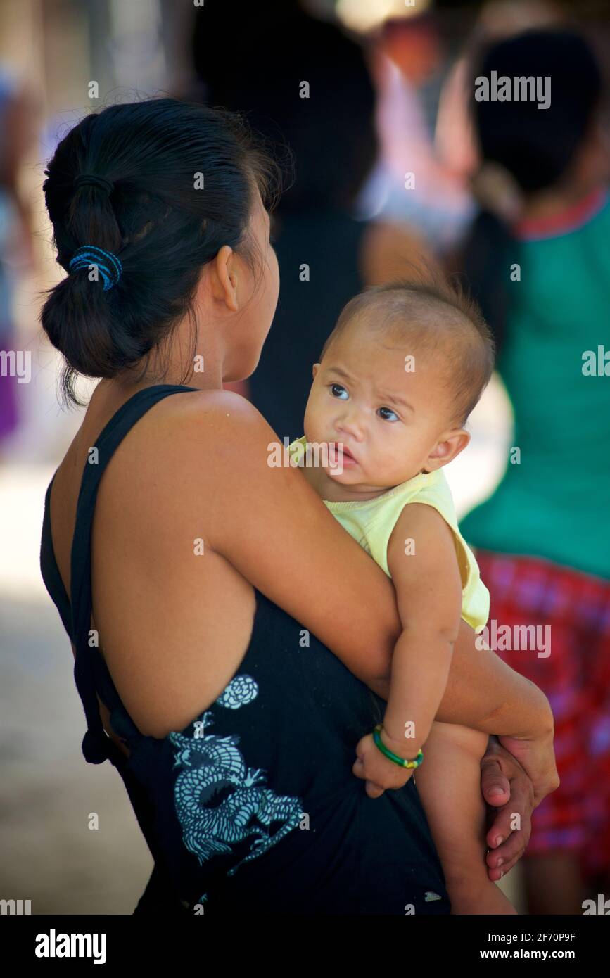 Filipina mother carrying her baby. Malapascua Isand, Philippines Stock ...