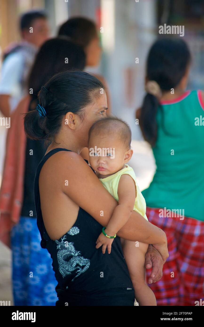 Filipina mother carrying her baby. Malapascua Isand, Philippines Stock ...