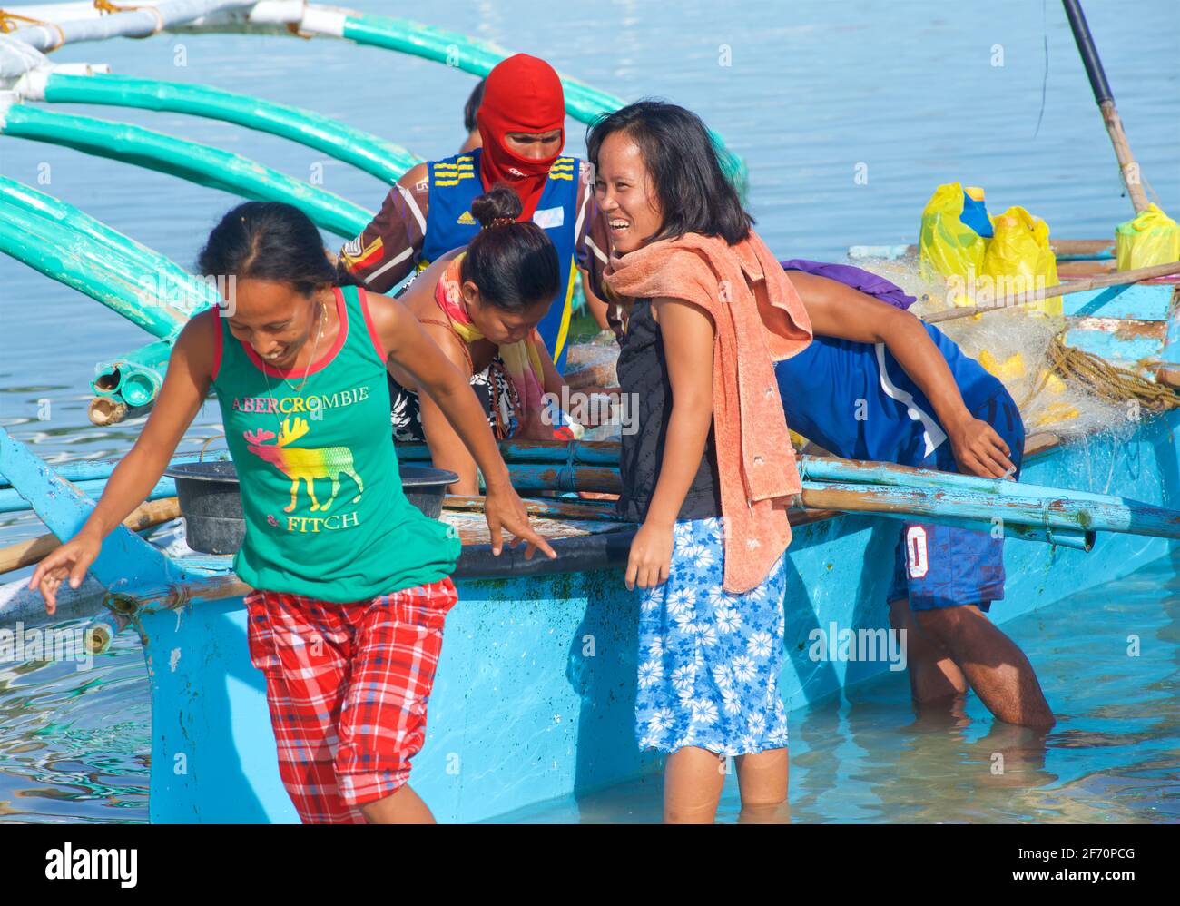 Supplies from Cebu mainland arriving by boat in a small outrigger canoe ...