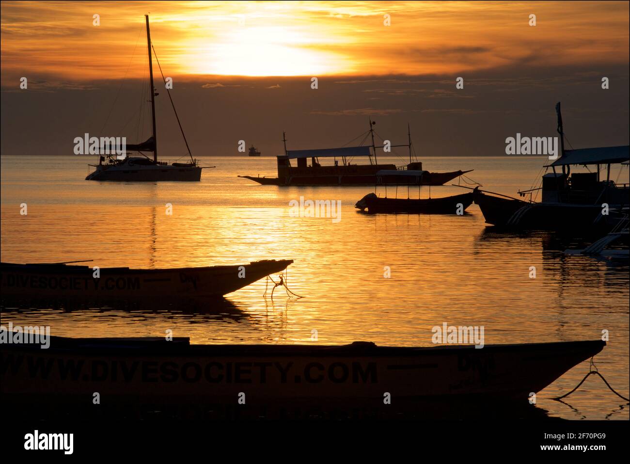 Boats moored in the bay off Logon village, Malapascua Island. Visayan ...