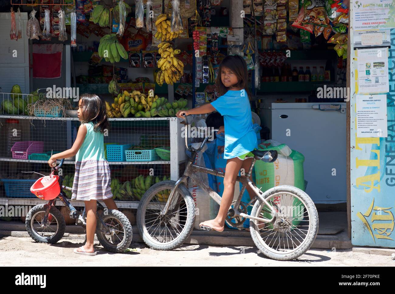 Filipino girls on their bicycles at a local village shop, Malapascua ...