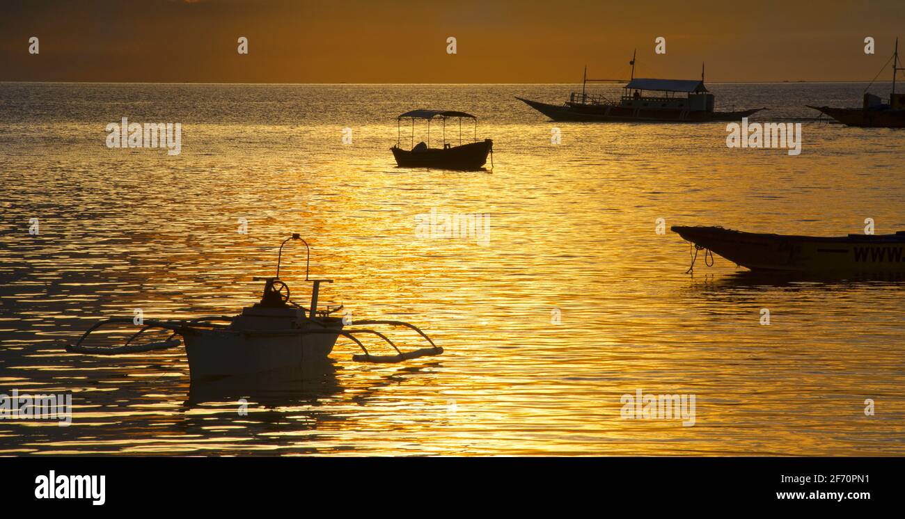 Boats moored in the bay off Logon village, Malapascua Island. Visayan ...