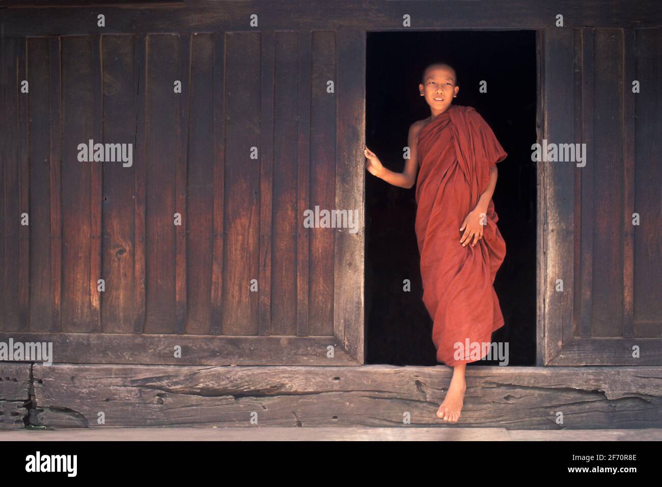 A Novice monk steps out from afternoon prayers. Bagaya Kyaung, Ava ...