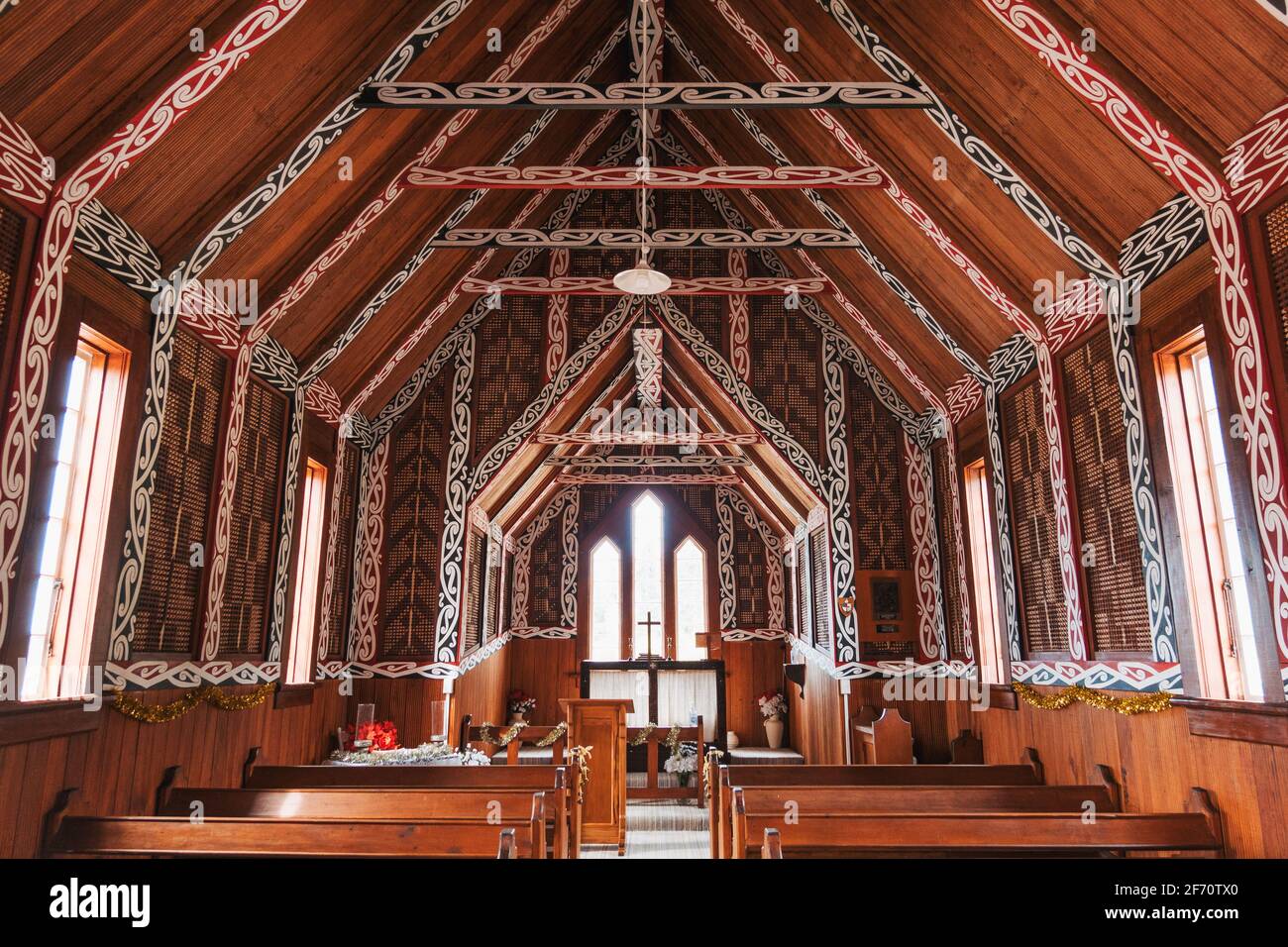 inside an ornate historic Anglican Māori church, lined with kowhaiwhai ...