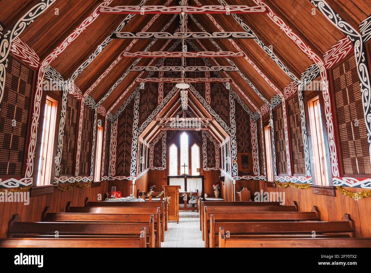 inside an ornate historic Anglican Māori church, lined with kowhaiwhai ...