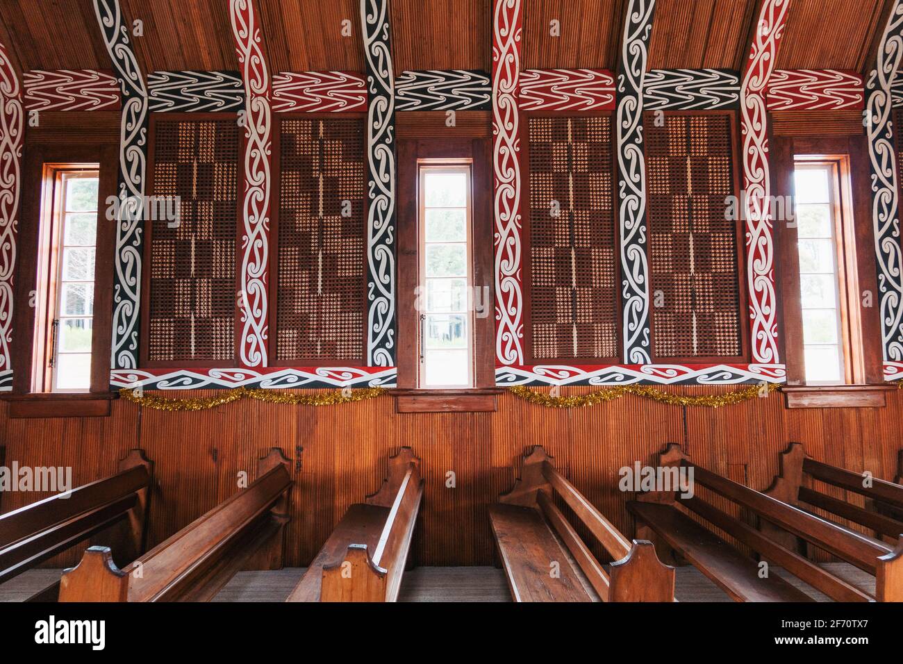 inside an ornate historic Anglican Māori church, lined with kowhaiwhai ...