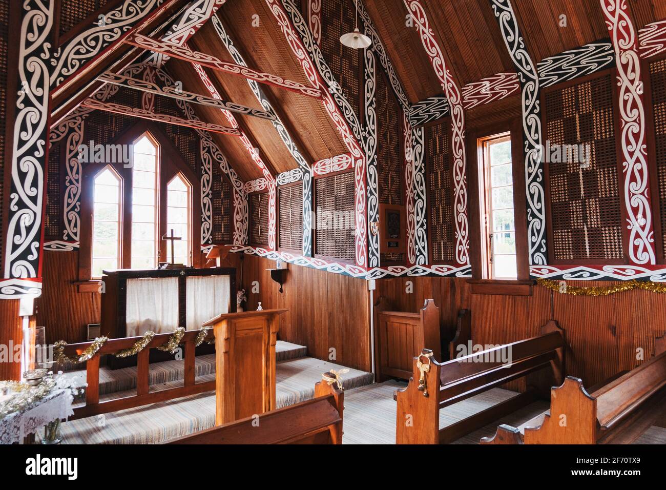 inside an ornate historic Anglican Māori church, lined with kowhaiwhai ...