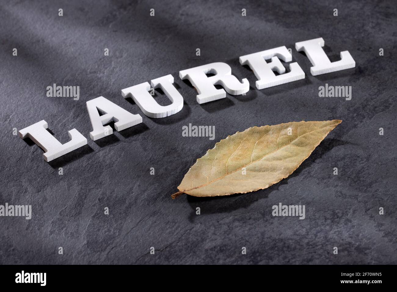 Laurus nobilis - Dry bay leaf. Laurel word in wooden letters Stock ...