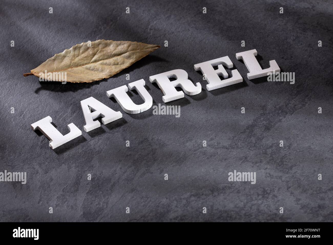 Laurus nobilis - Dry bay leaf. Laurel word in wooden letters Stock ...