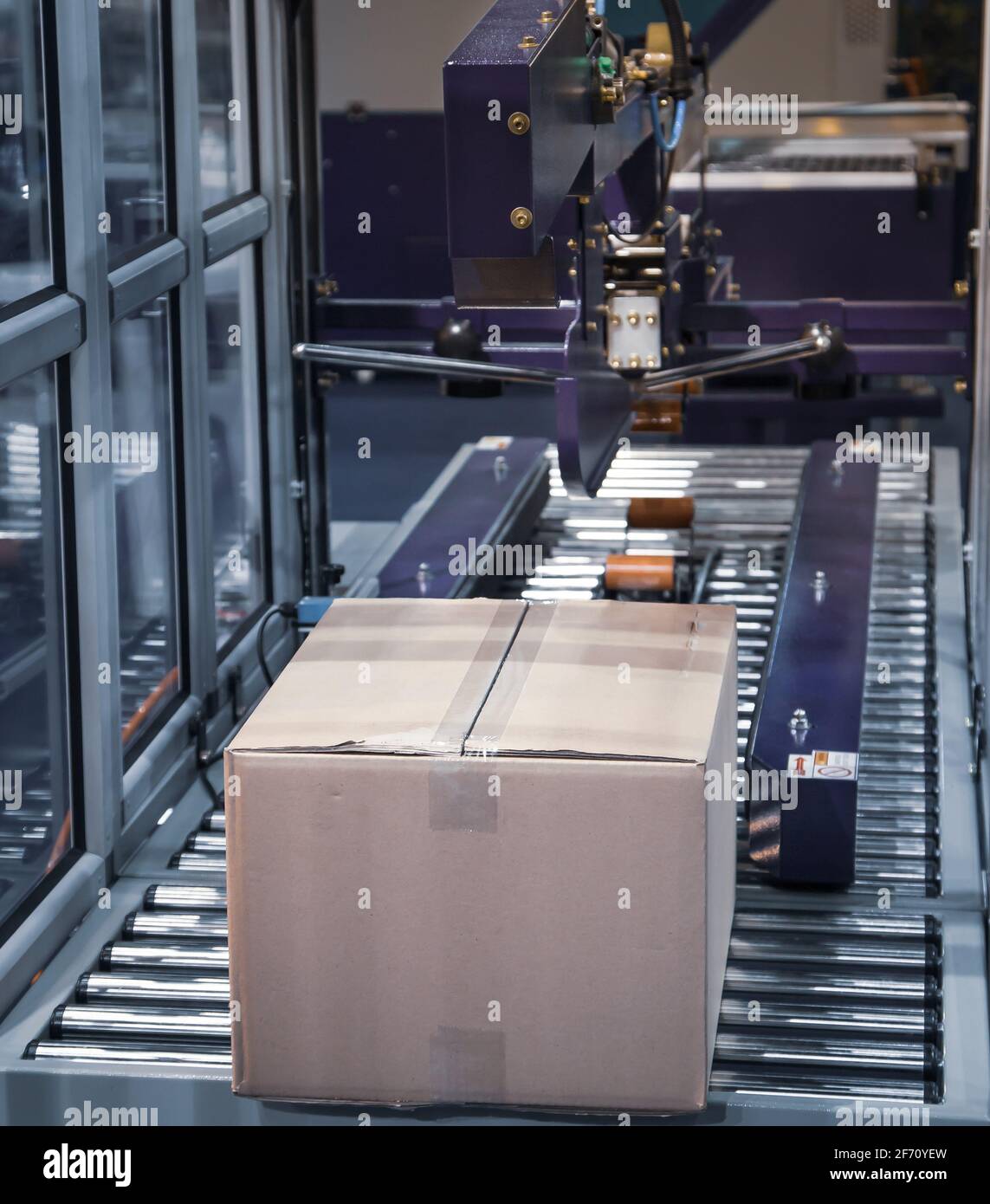 Carton, cardboard tape sealing machine. Industrial logistics warehouse ...