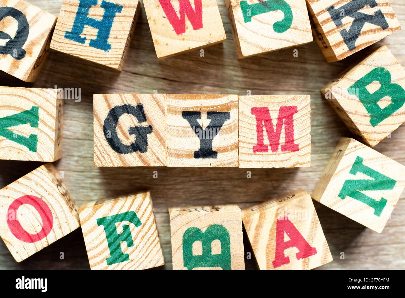 Alphabet letter block in word gym with another on wood background Stock ...