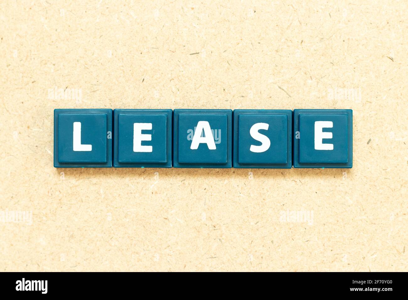 Tile alphabet letter in word lease on wood background Stock Photo - Alamy
