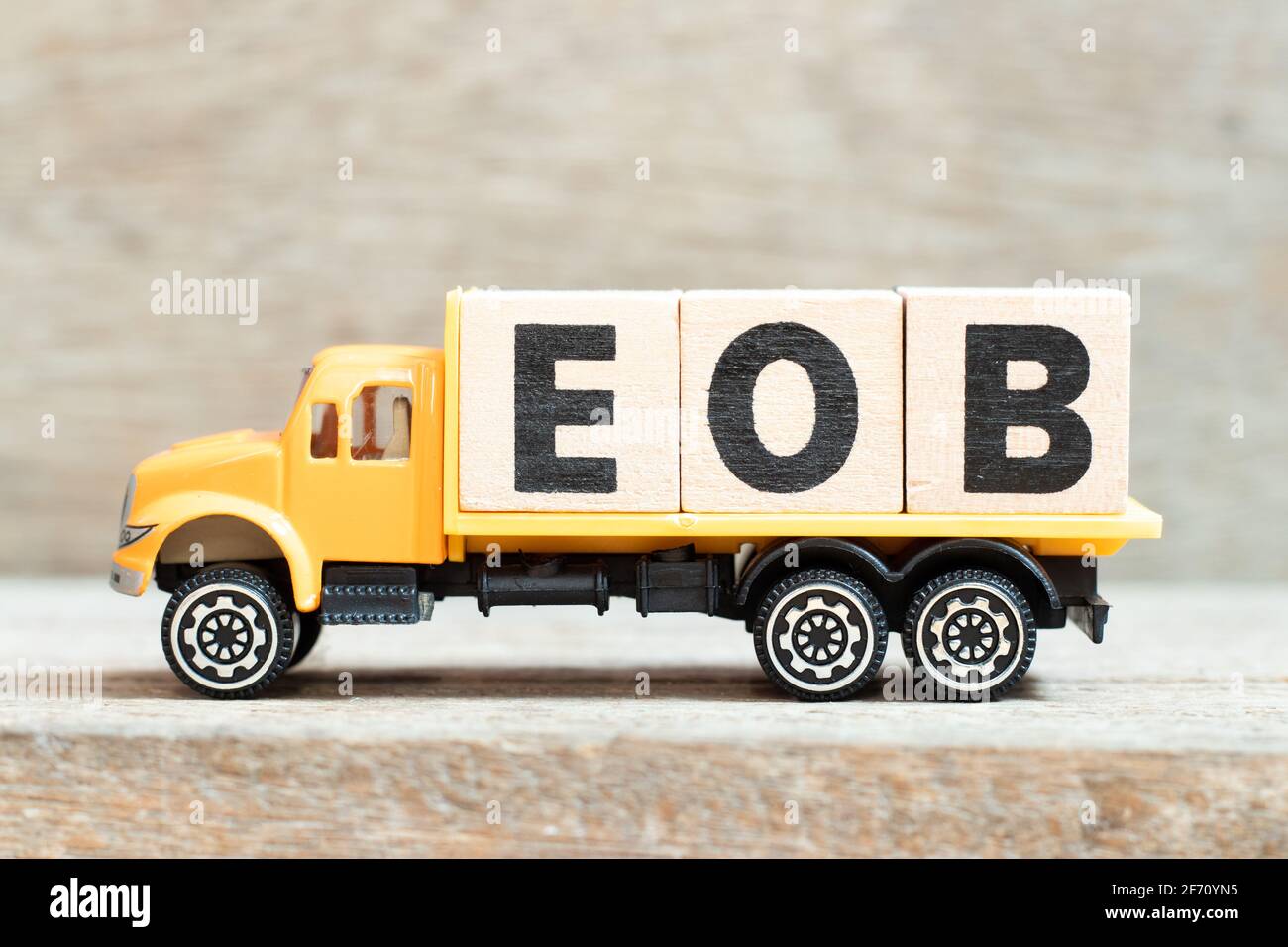 Toy truck hold alphabet letter block in word EOB (Abbreviation of end ...