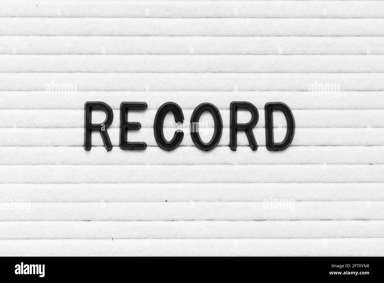 Black color letter in word record on white felt board background Stock ...