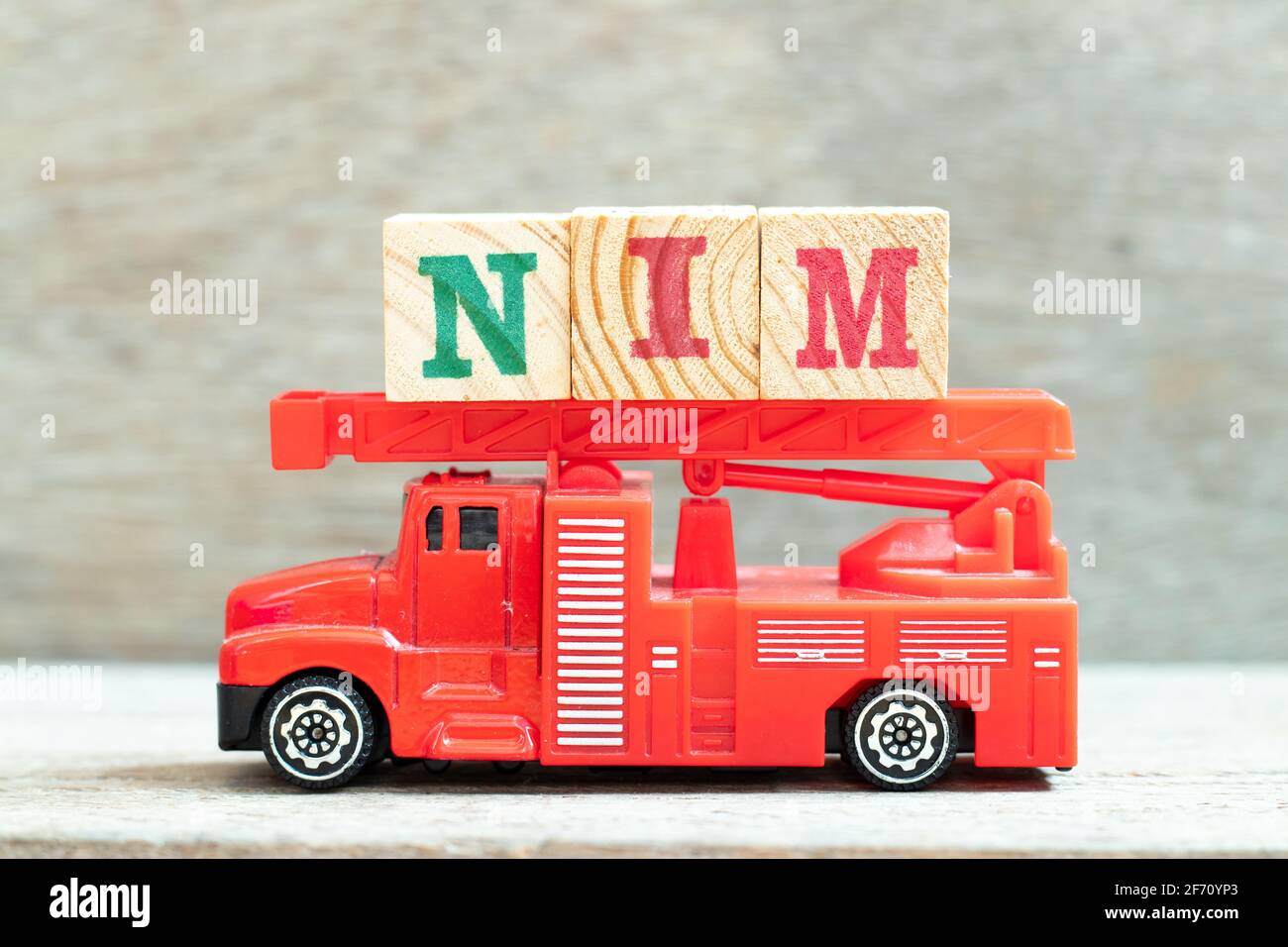 Fire ladder truck hold letter block in word NIM (Abbreviation of Net ...