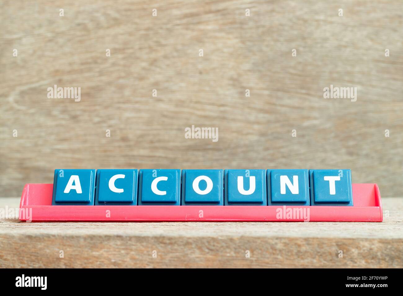 Tile alphabet letter with word account in red color rack on wood ...
