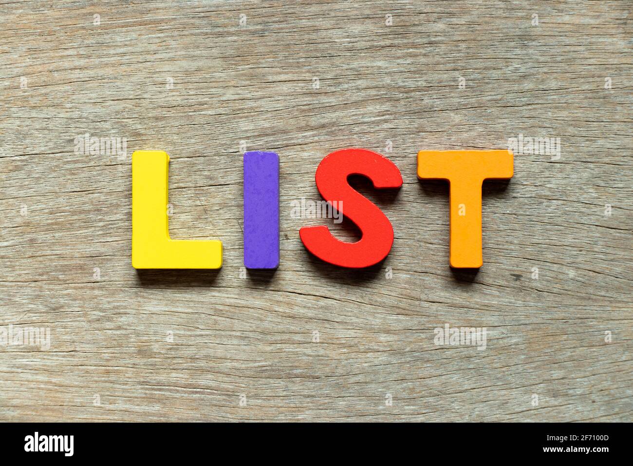 Color alphabet letter in word list on wood background Stock Photo - Alamy
