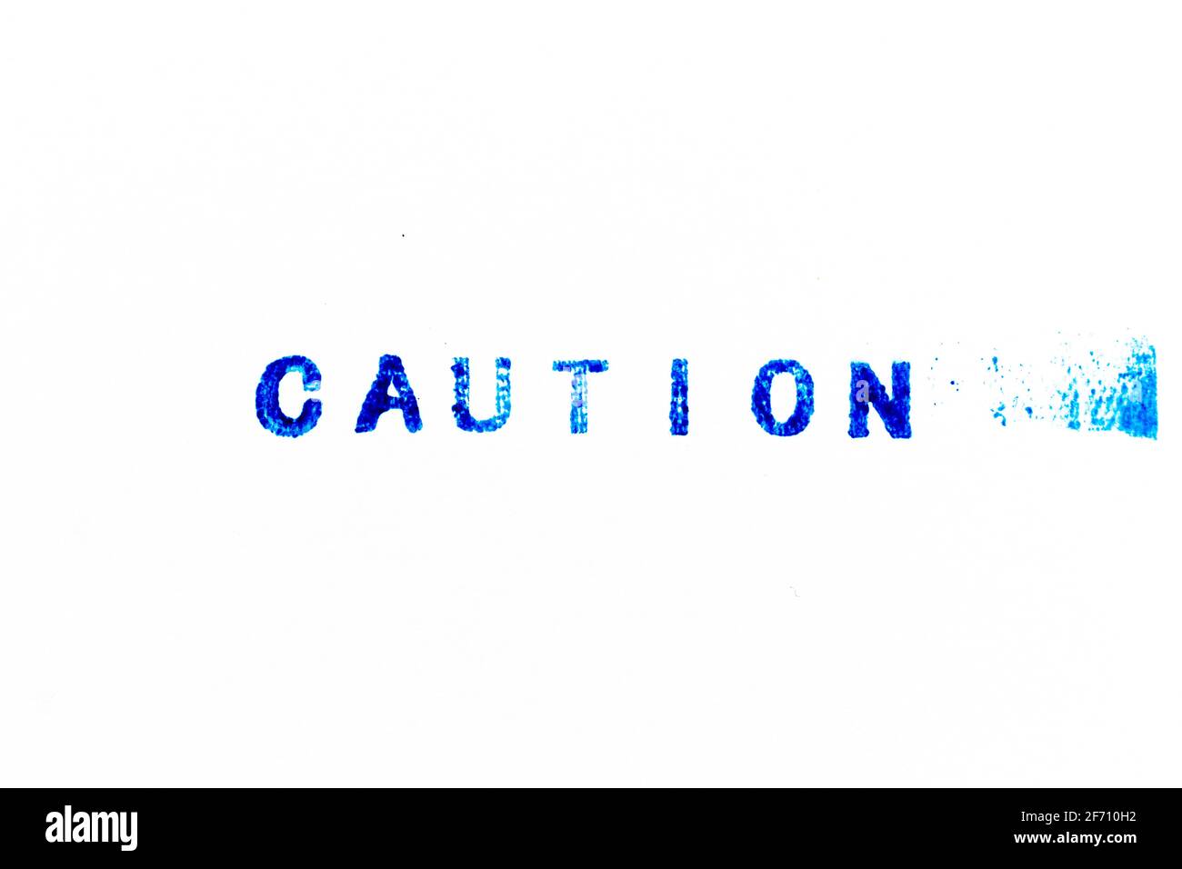 Blue color ink of rubber stamp in word caution on white paper ...