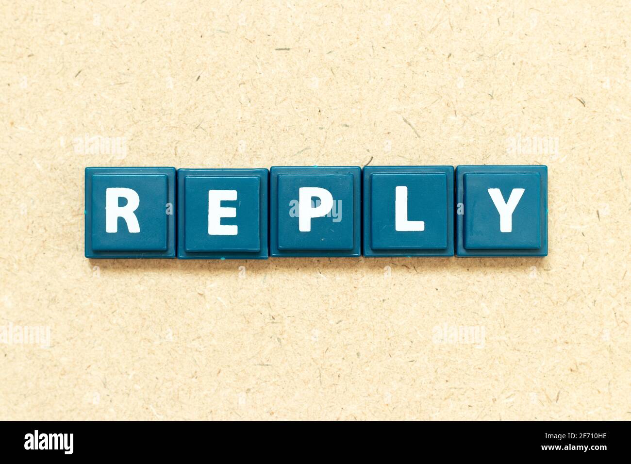 Tile alphabet letter in word reply on wood background Stock Photo - Alamy