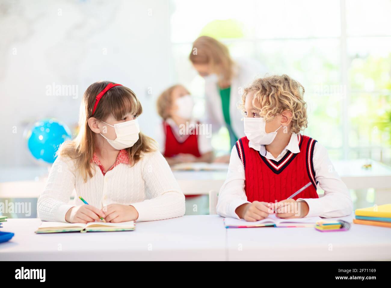 Kids in face mask in school class. Child back to school after ...