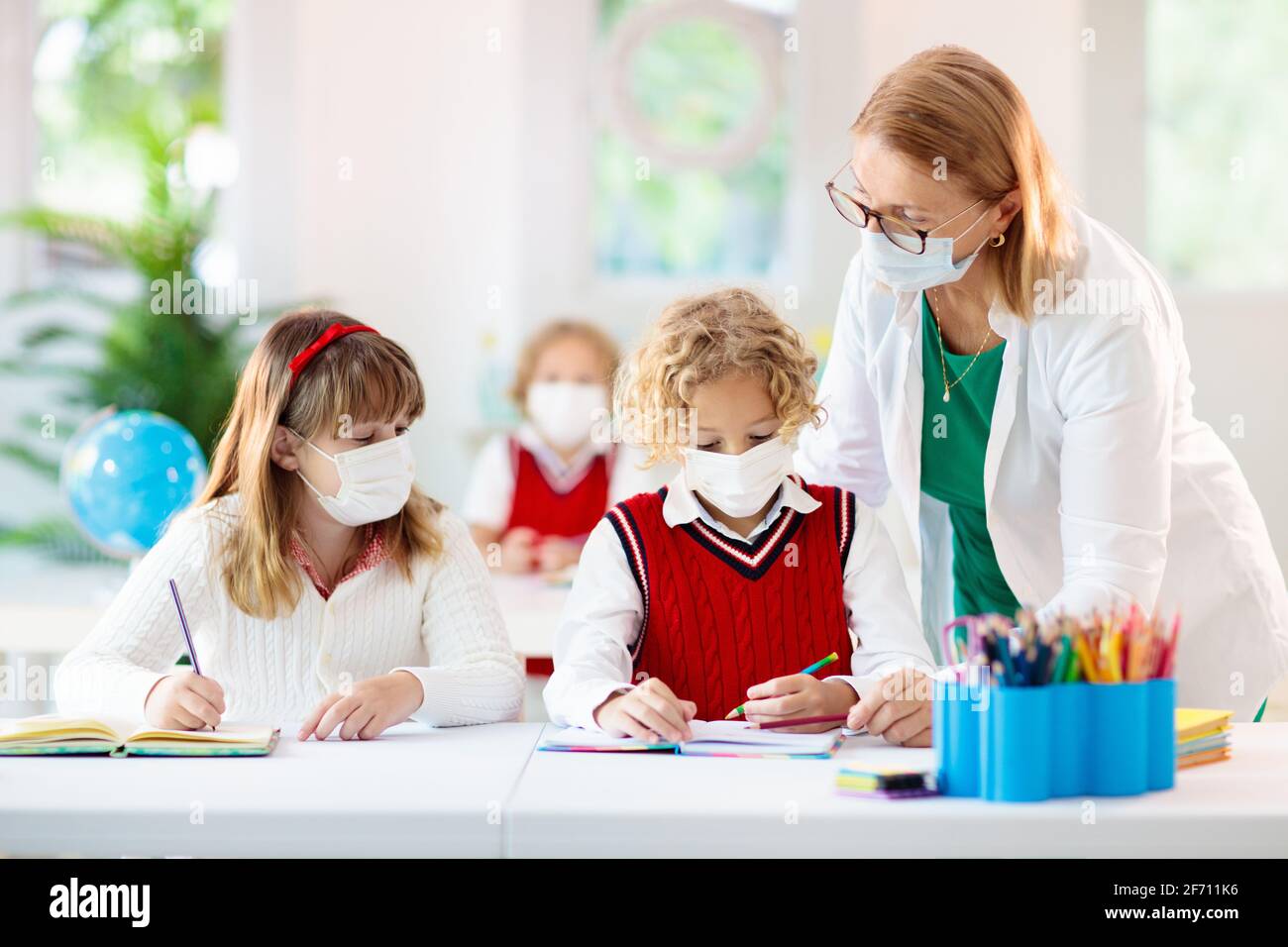 Kids in face mask in school class. Child back to school after ...