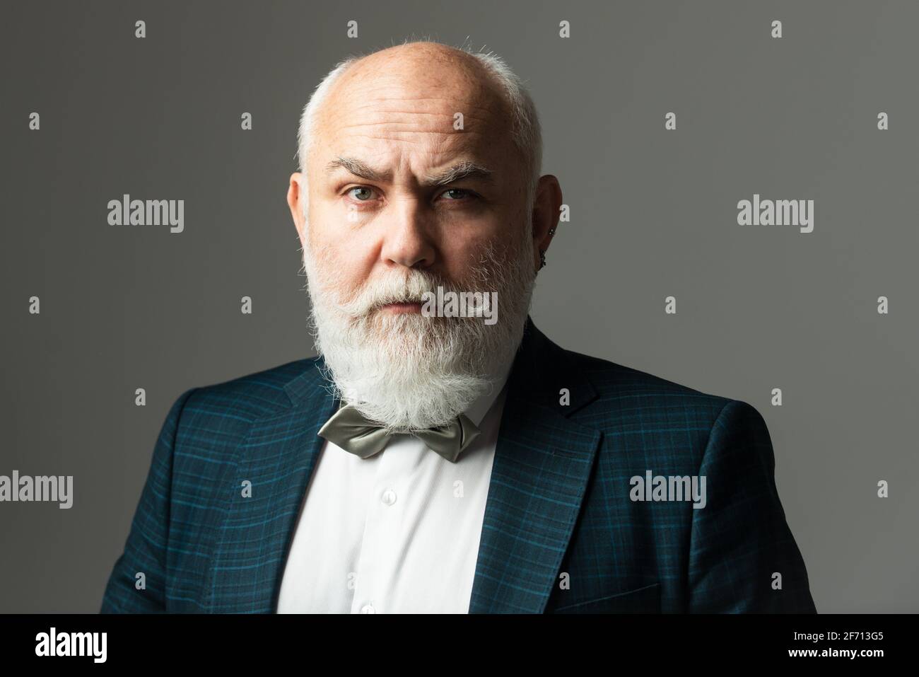 Senior Man in Suit. Head and shoulders portrait of a bearded middle ...