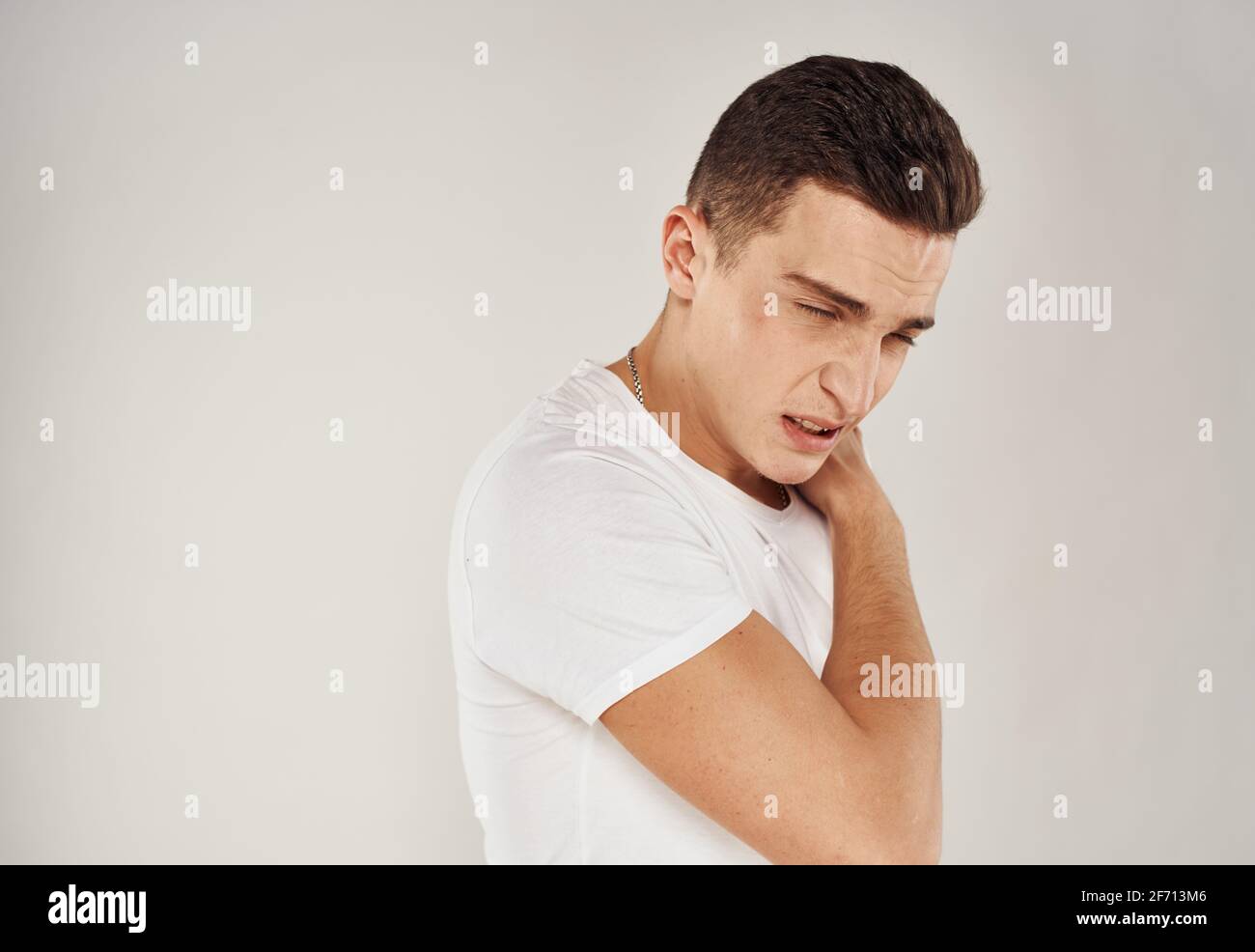 Guy in a white T-shirt sadness emotions model light background ...