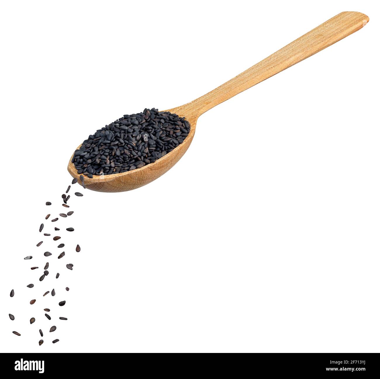 black sesame seeds falling from wooden spoon Stock Photo - Alamy