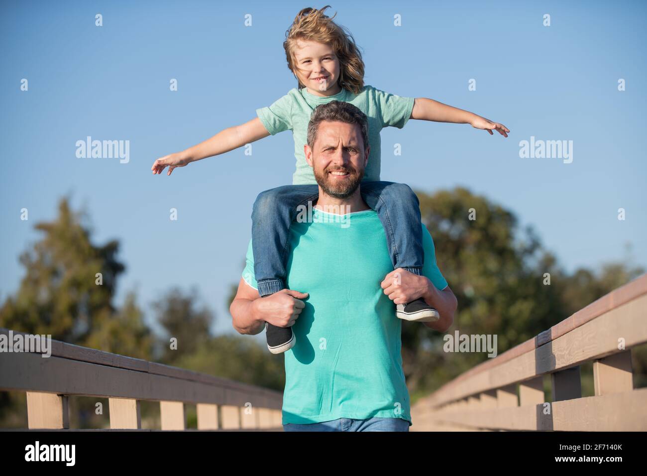 Father piggyback his son outside. Happy family Stock Photo - Alamy