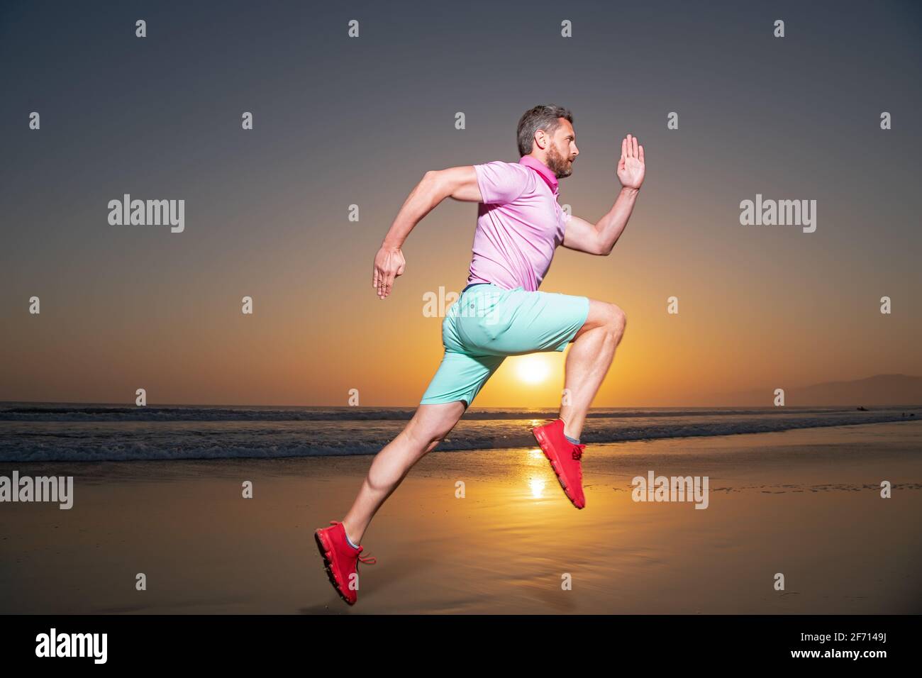 Athletic young man running in the nature. Fit man fitness model working ...