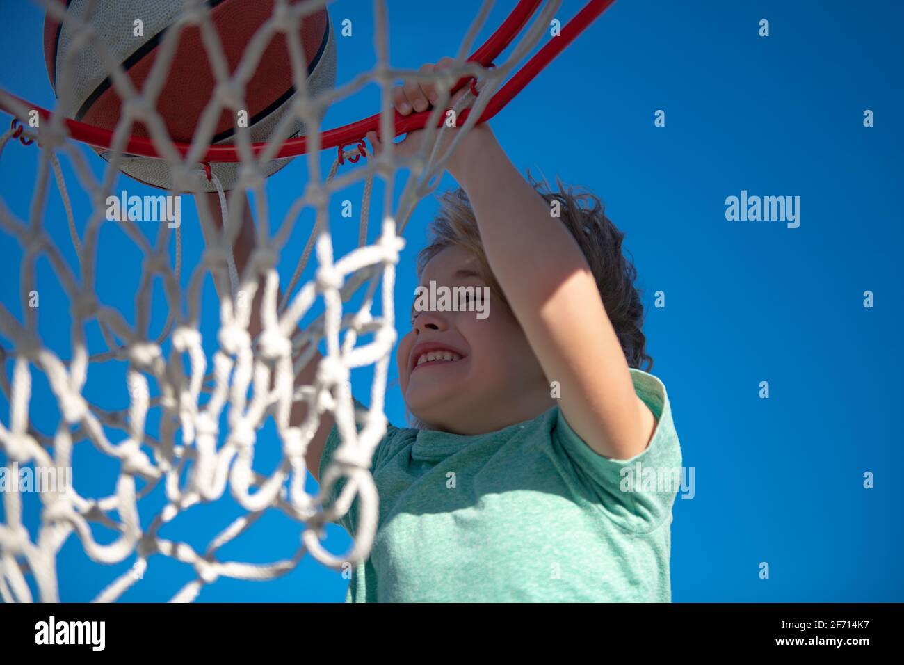 Basketball child player running up and dunking the ball. Funny excited ...