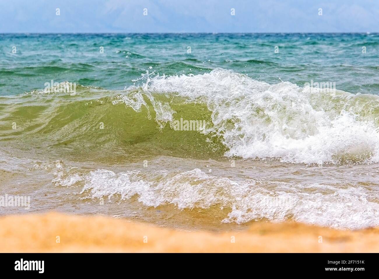 Landscape with the image of wave on Lake Baikal close-up. Beach of the ...