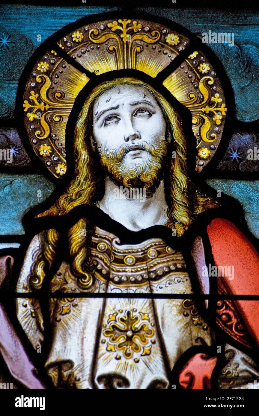 A Victorian stained glass window depicting Jesus Christ looking to ...