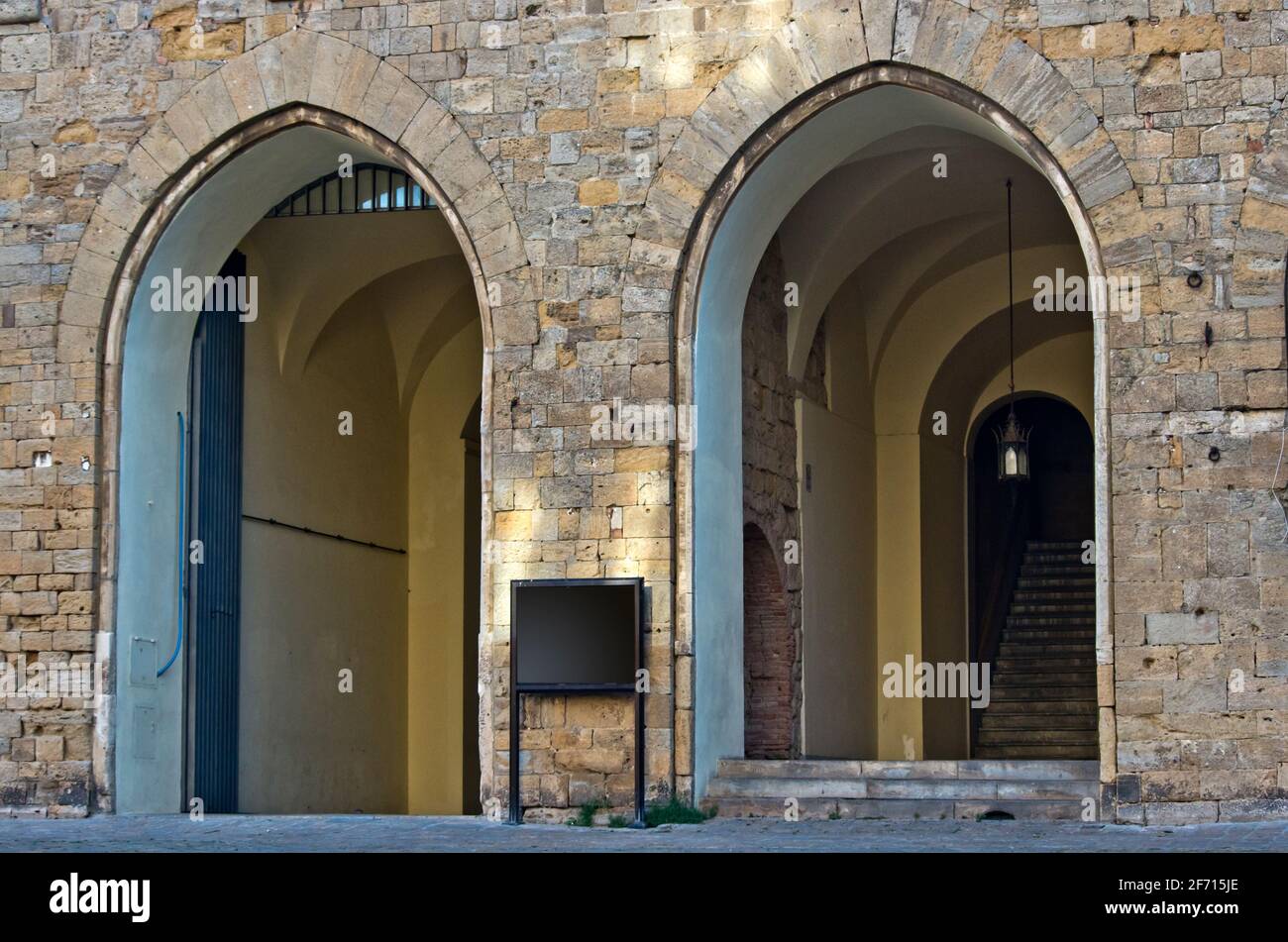 ancient arch of the stone gate in the medieval walls of the historic ...
